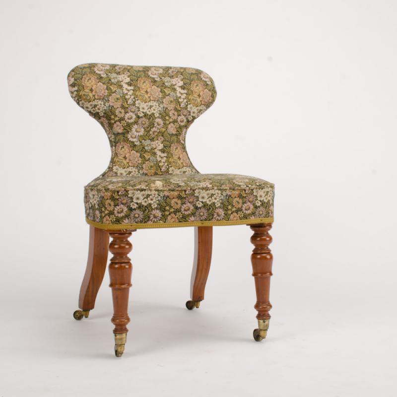 A nineteenth century Irish upholstered chair, brass casters and ...