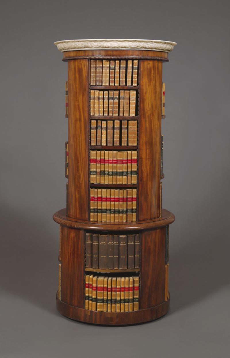 A Mahogany Circular Bookcase With A Statuary Dished Marble Top
