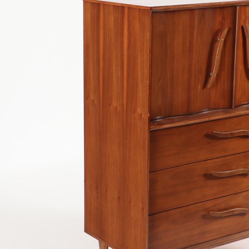 A mid century modern walnut highboy cabinet circa 1960.