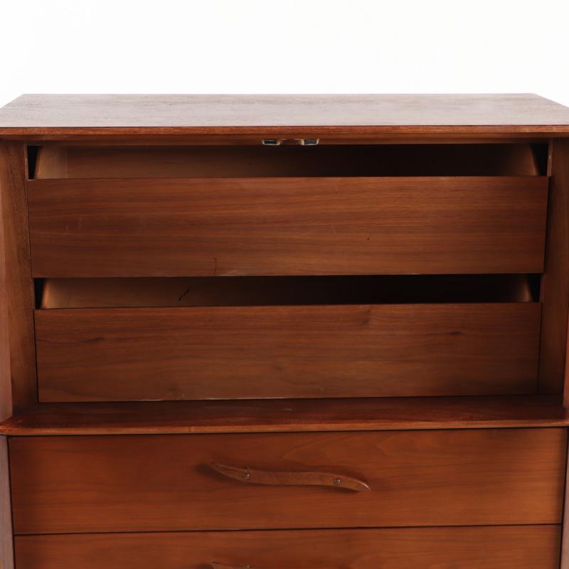 A mid century modern walnut highboy cabinet circa 1960.