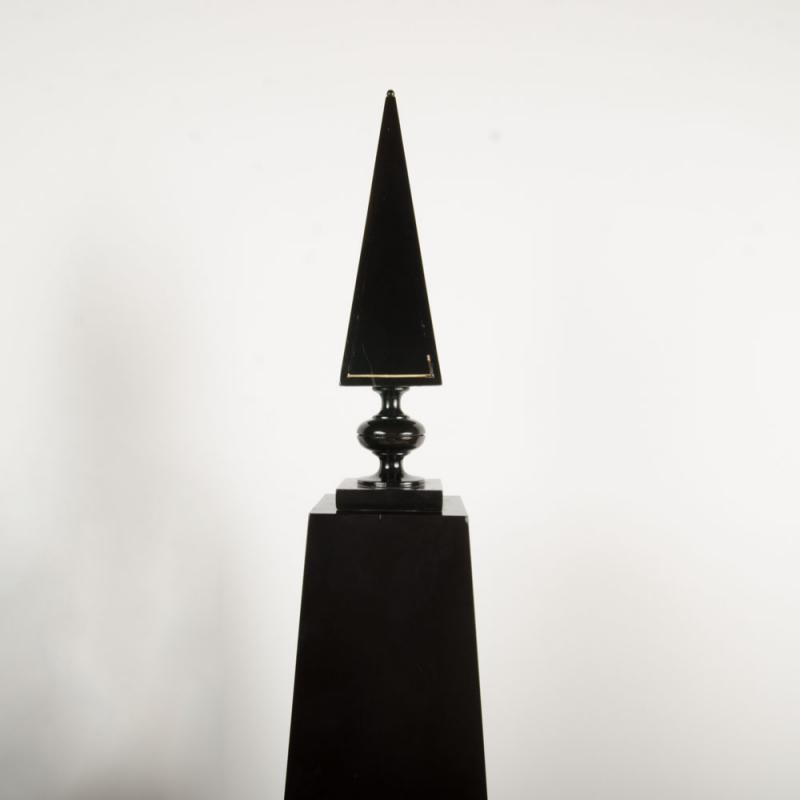 A pair of tall black decorative obelisks