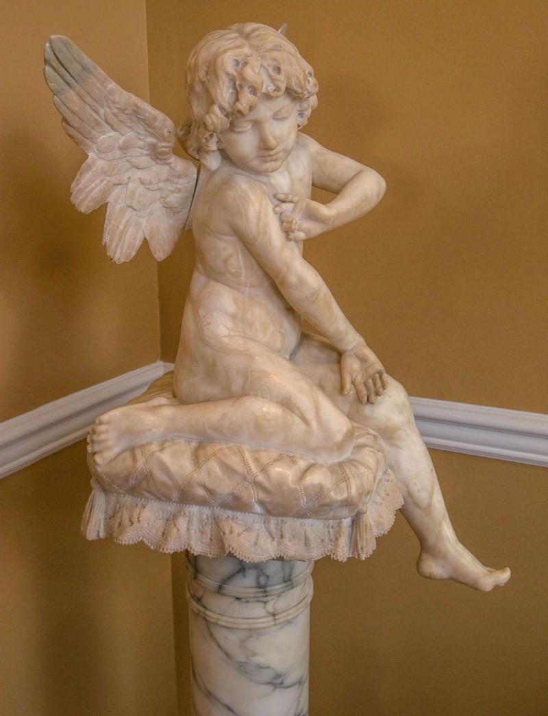 Alabaster Figure Winged Angel Sitting On A Pillow on an Alabaster Pedestal