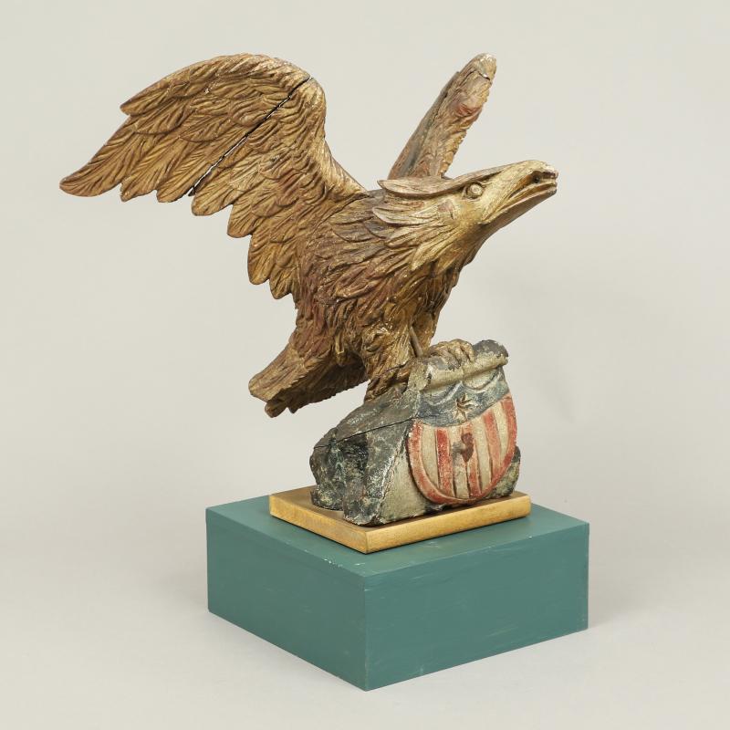 CARVED EAGLE WITH SWEPT-BACK WINGS PERCHED ON A ROCK WITH SHIELD