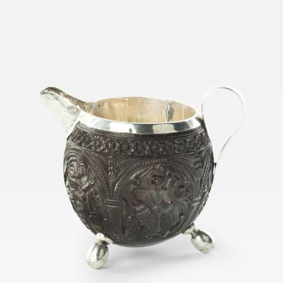 An Indian coconut shell milk jug