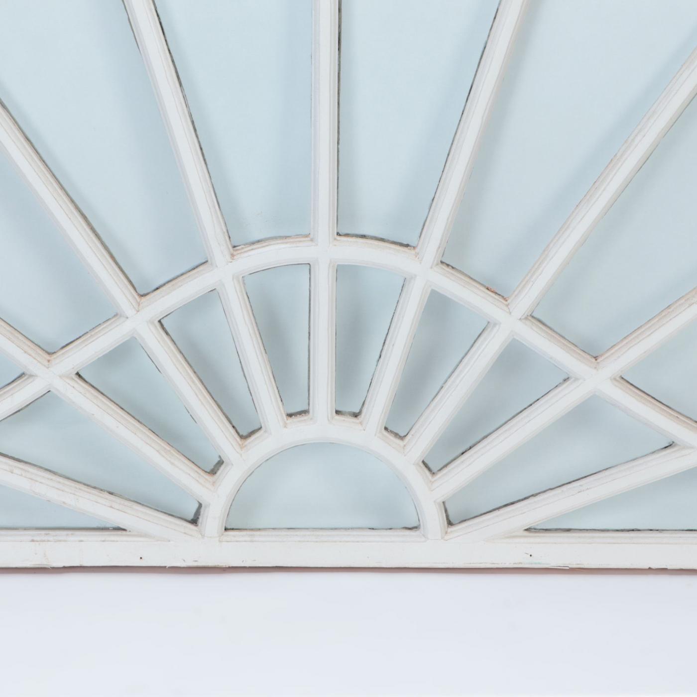 A half round painted iron transome window, French, C 1900.