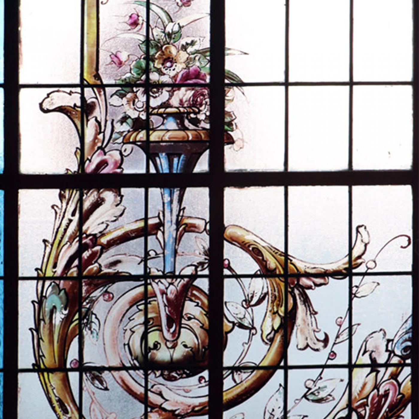 A large painted and leaded glass window in iron frame circa 1900.