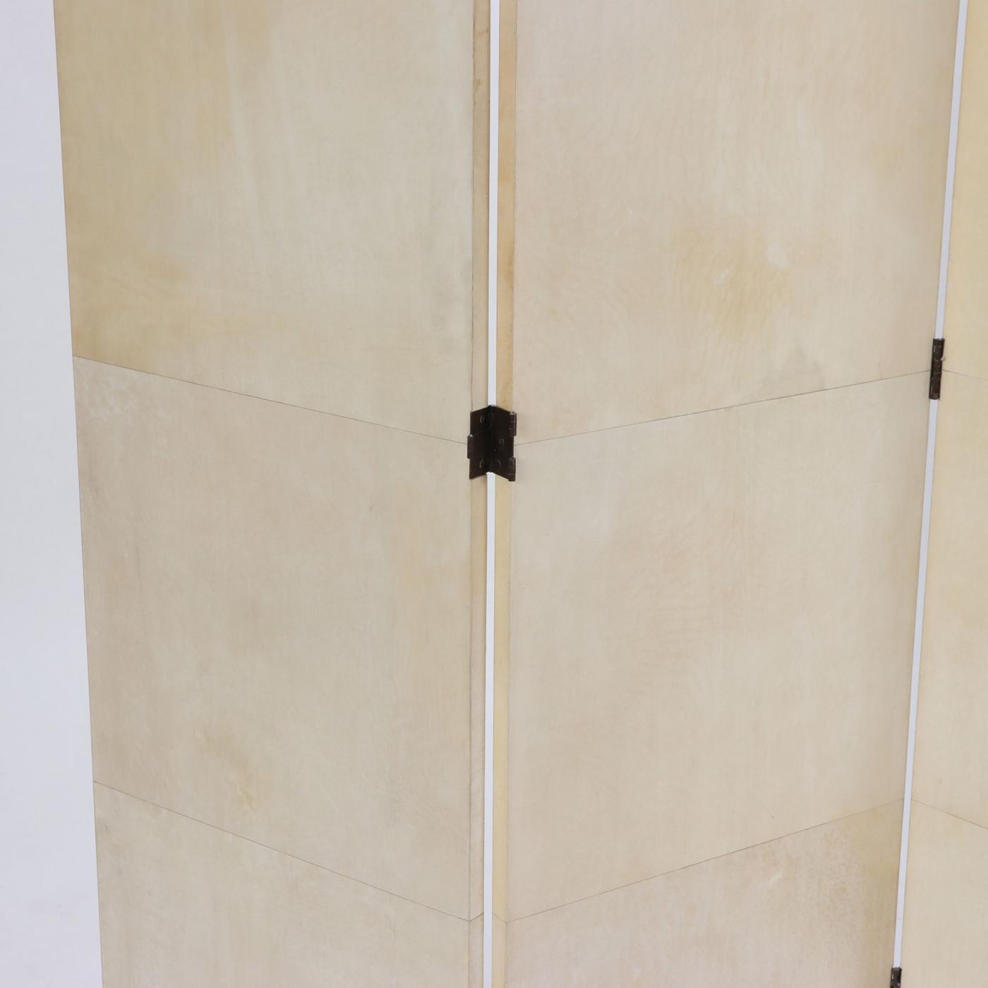 A pair of Contemporary parchment covered three panel folding screens.