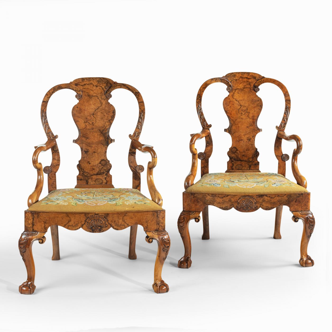A pair of George II style walnut open arm chairs, possibly by Charles Tozer