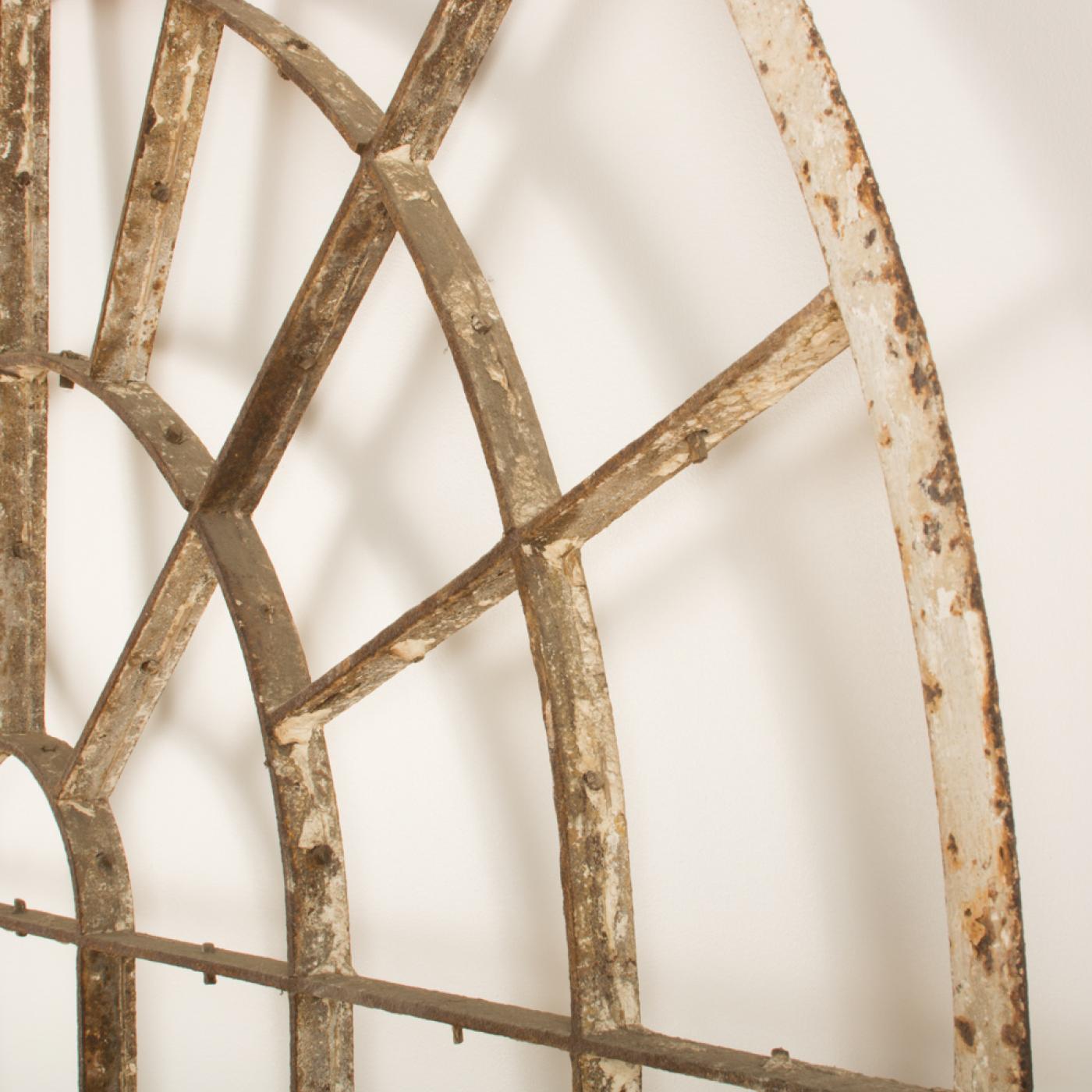 A set of three French arched top wrought iron windows, circa 1880