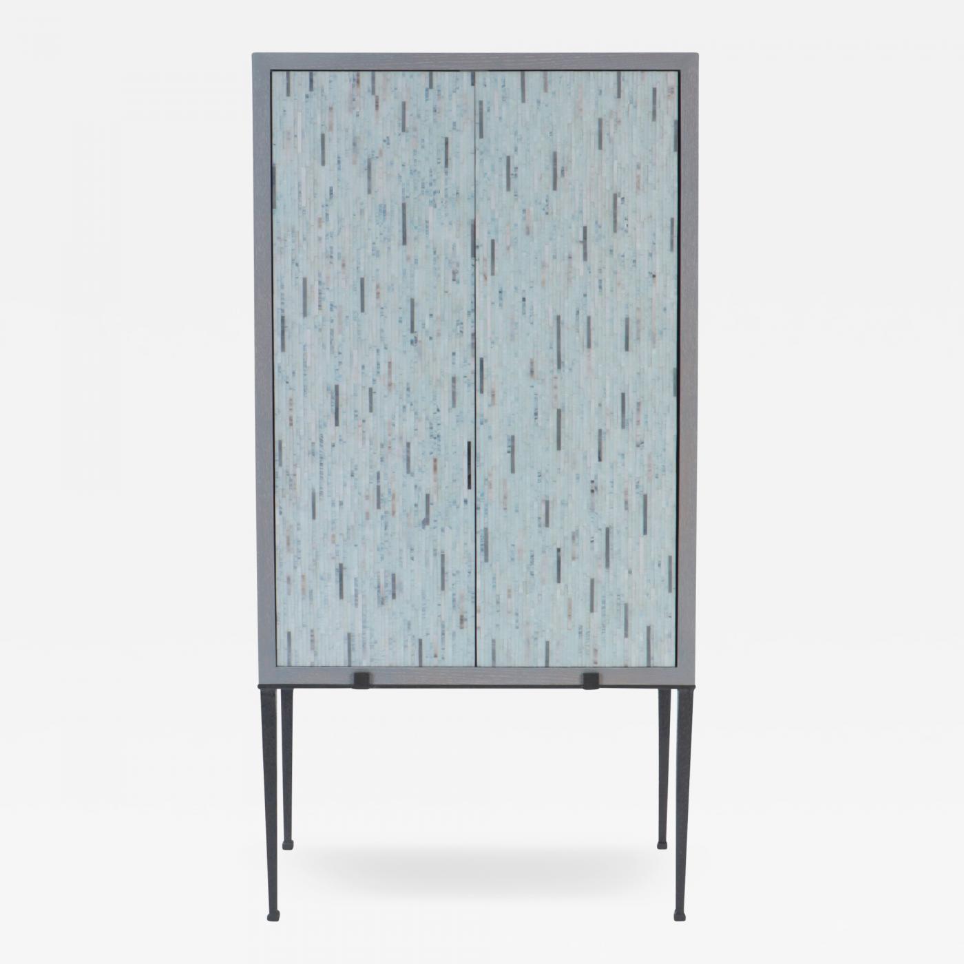 A stylish custom-made cerused oak cabinet with mosaic glass doors.