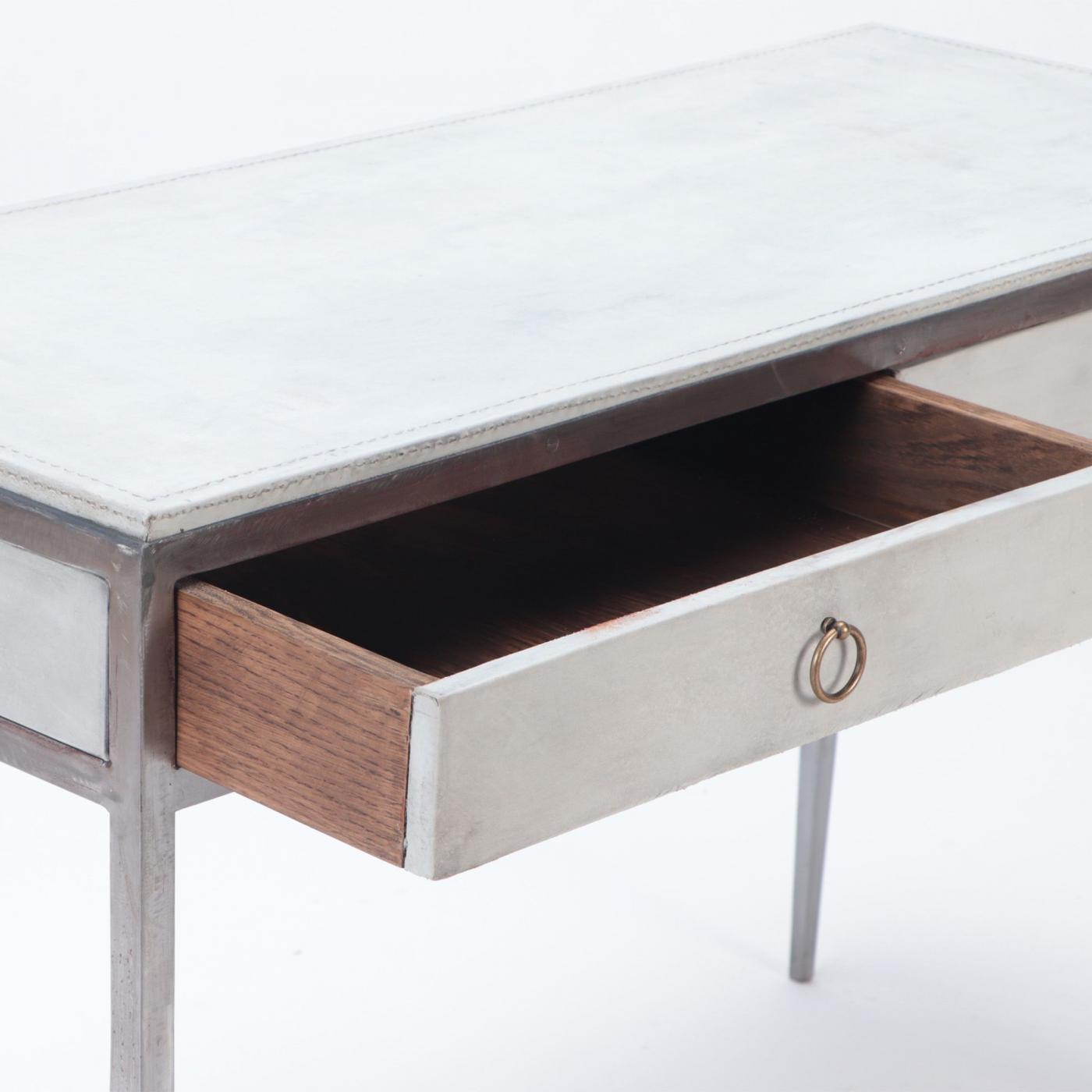 A white leather and polished iron writing desk. Contemporary.