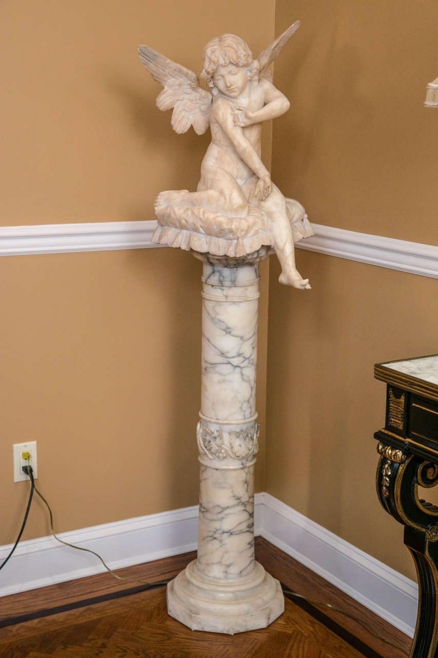 Alabaster Figure Winged Angel Sitting On A Pillow on an Alabaster Pedestal