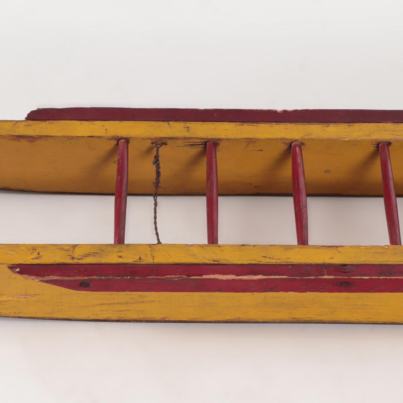An Antique original yellow and red painted New England wood log sled.