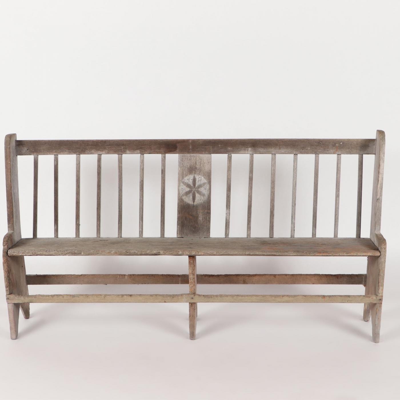 An antique wooden bench circa 1800.