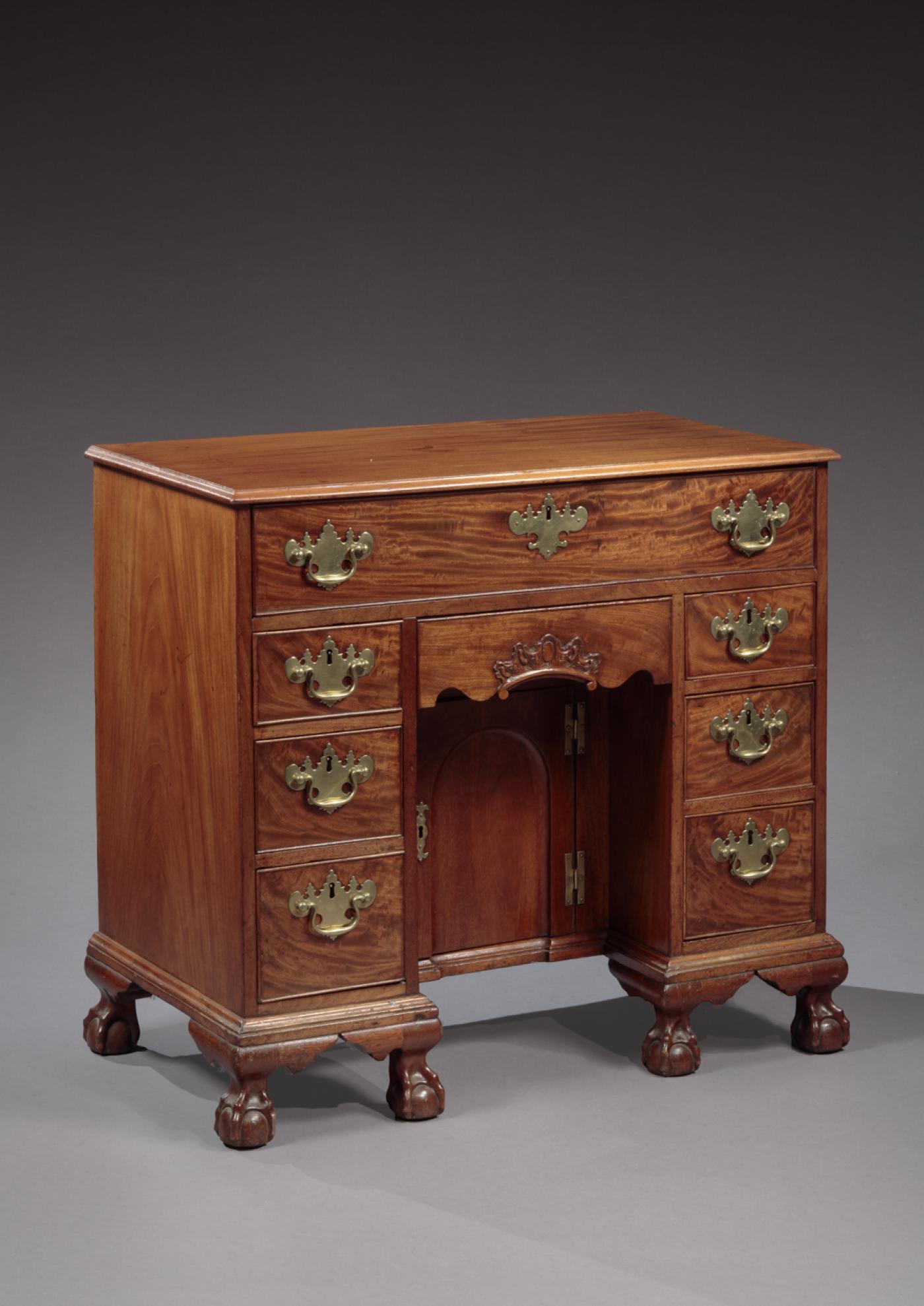 CHIPPENDALE KNEEHOLE DESK WITH BALL AND CLAW FEET AND A CARVED DRAWER