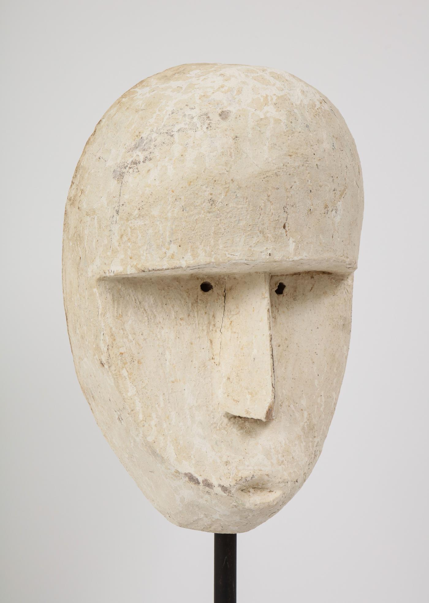 Pair of Balinese carved modernist plaster mask sculptures