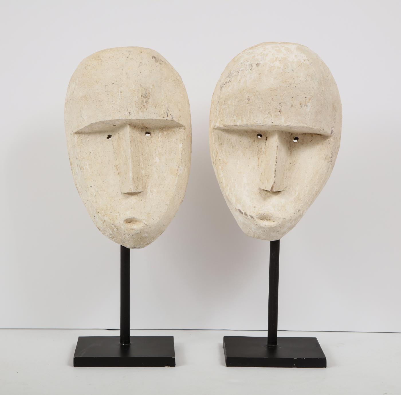 Pair of Balinese carved modernist plaster mask sculptures