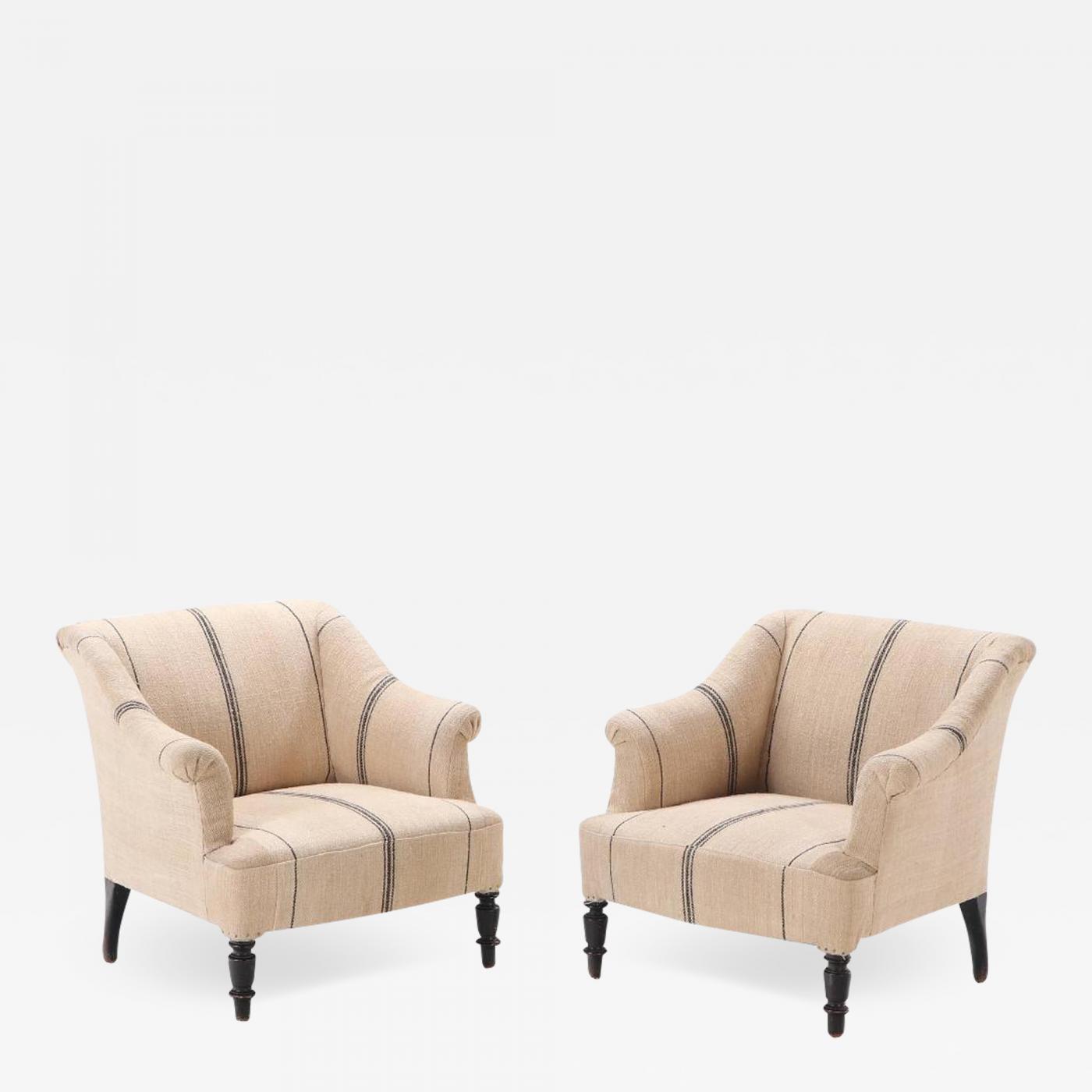 Pair of French Napoleon III boudoir chairs C 1870 on ebonized turned feet.