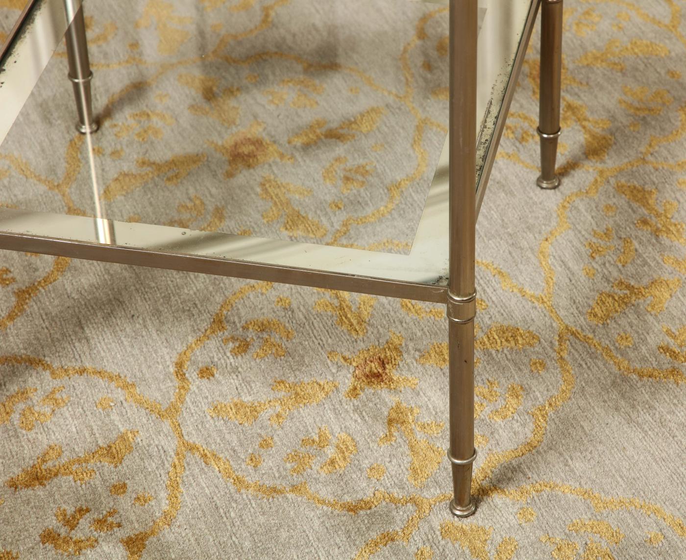 Pair of two-tiered silver gilt side tables