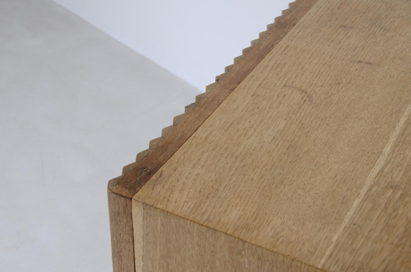 Small storage unit in light oak with ribbed wood front.