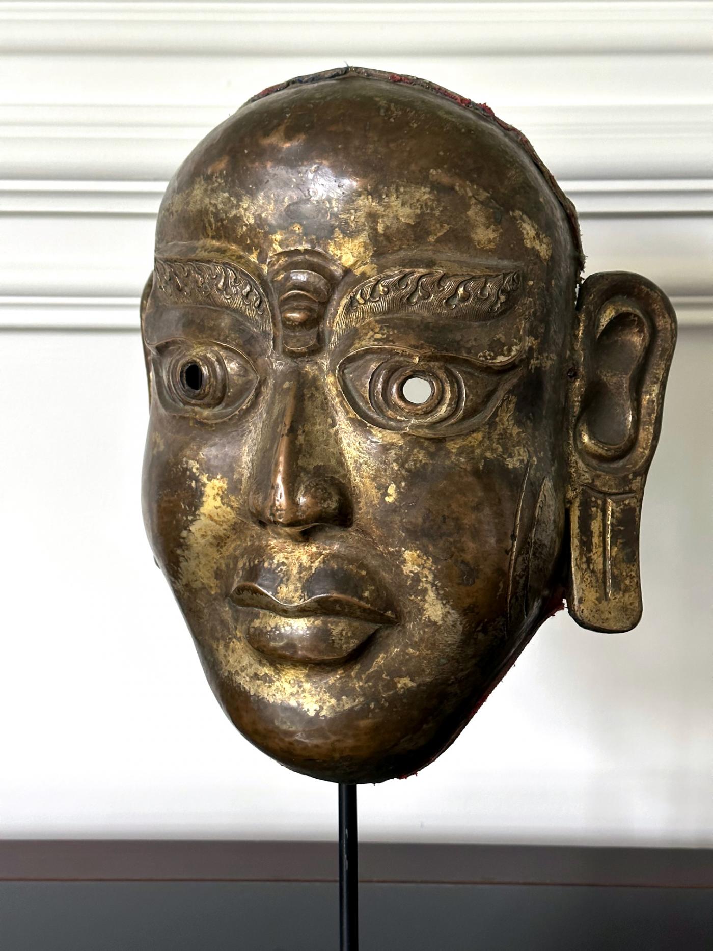 Tibetan Gilt Copper Alloy Mask on Display Stand